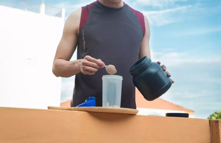 muž dělat proteinový koktejl